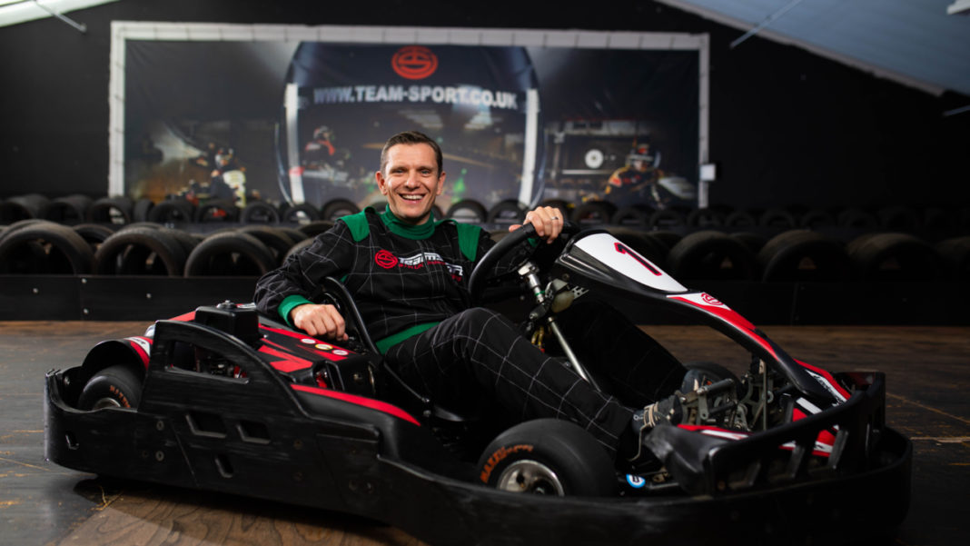 CEO Dom Gaynor of TeamSport waves the checked starting flag once again ...