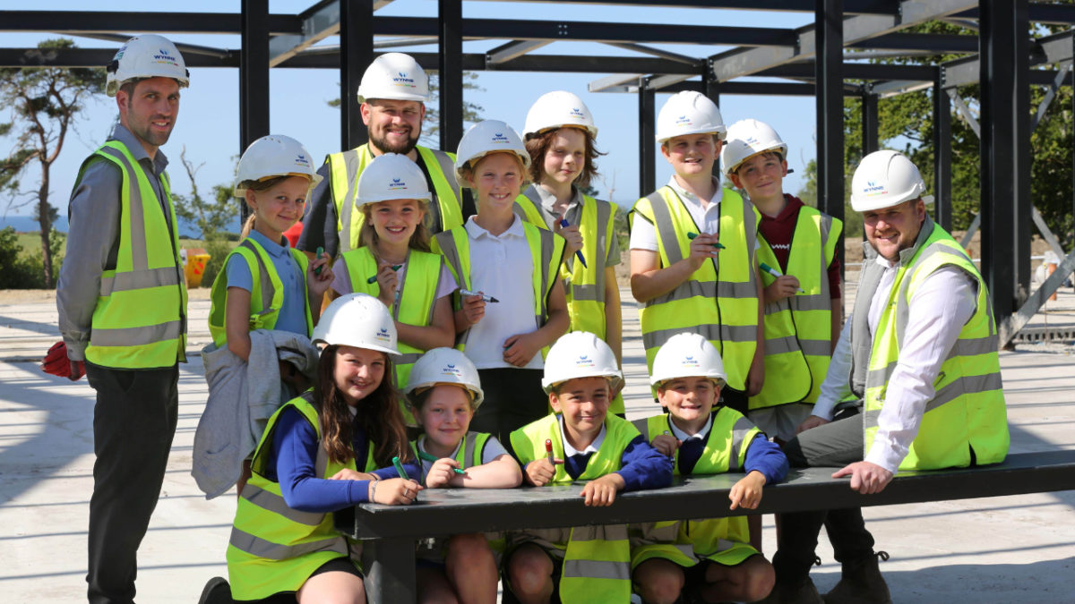 Signed, steel, delivered! Pupils write names onto the structure of new ...